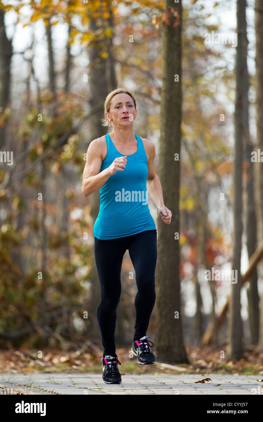 Fit woman jogging on a path Stock Photo - Alamy