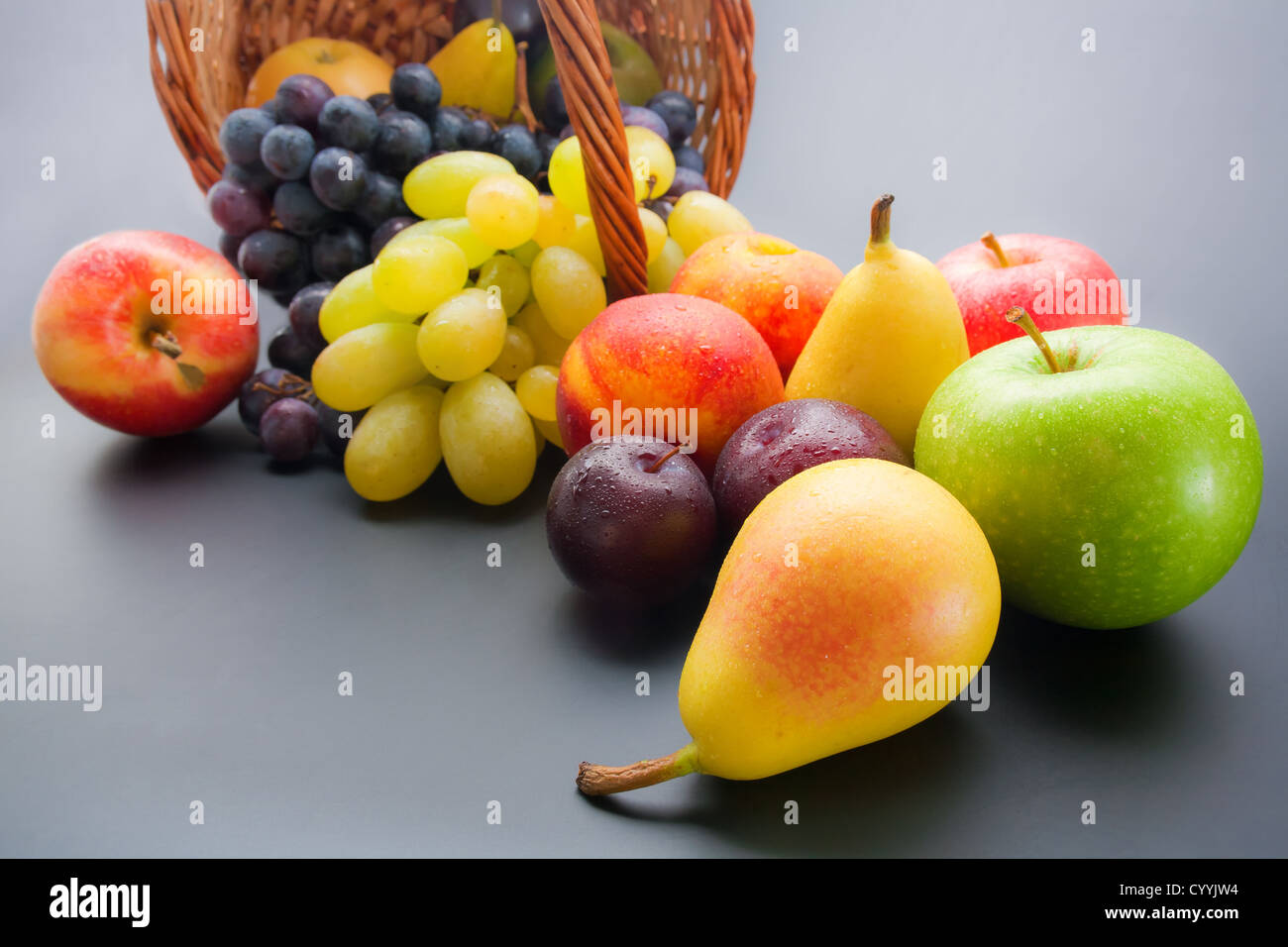 Various fresh ripe fruits close-up: plums, peaches, pears, apples and ...