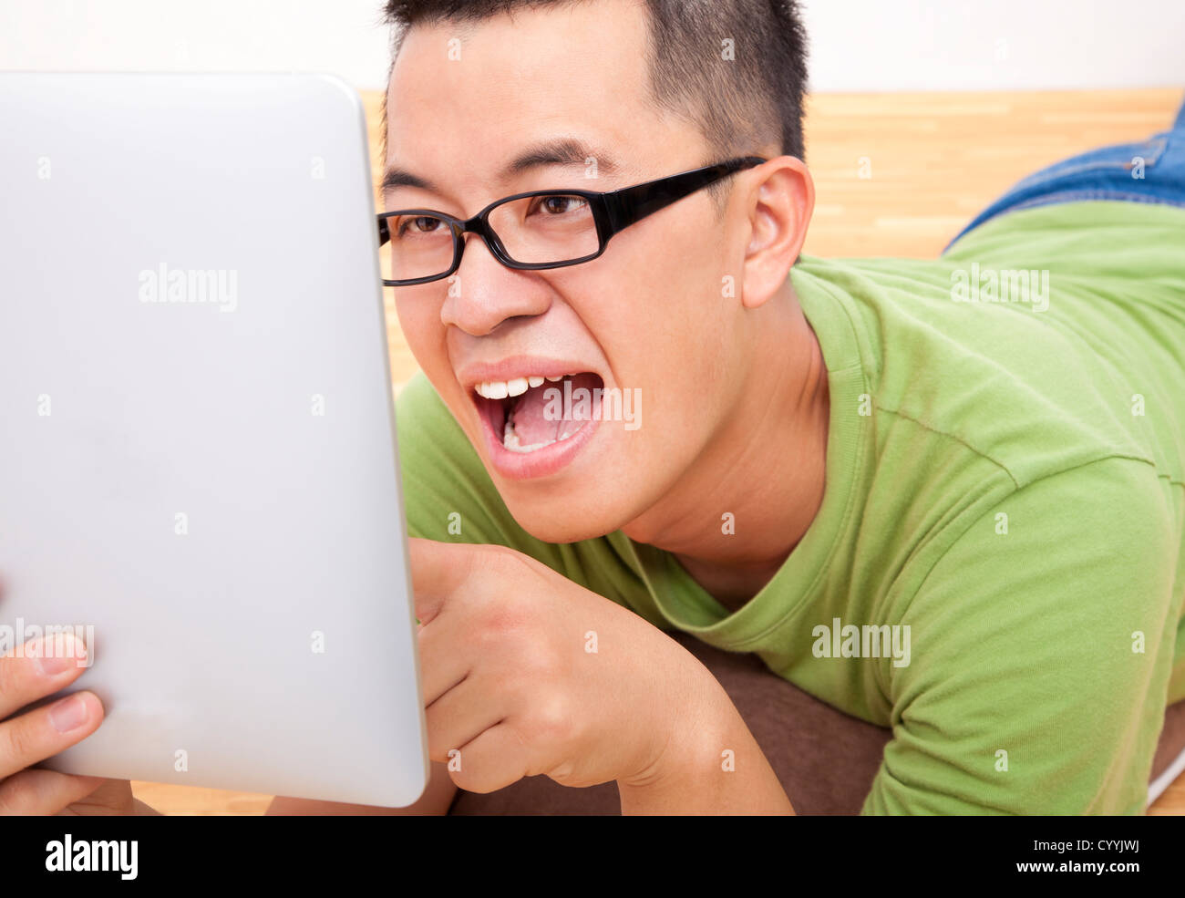 happy young man with touch pad computer Stock Photo - Alamy