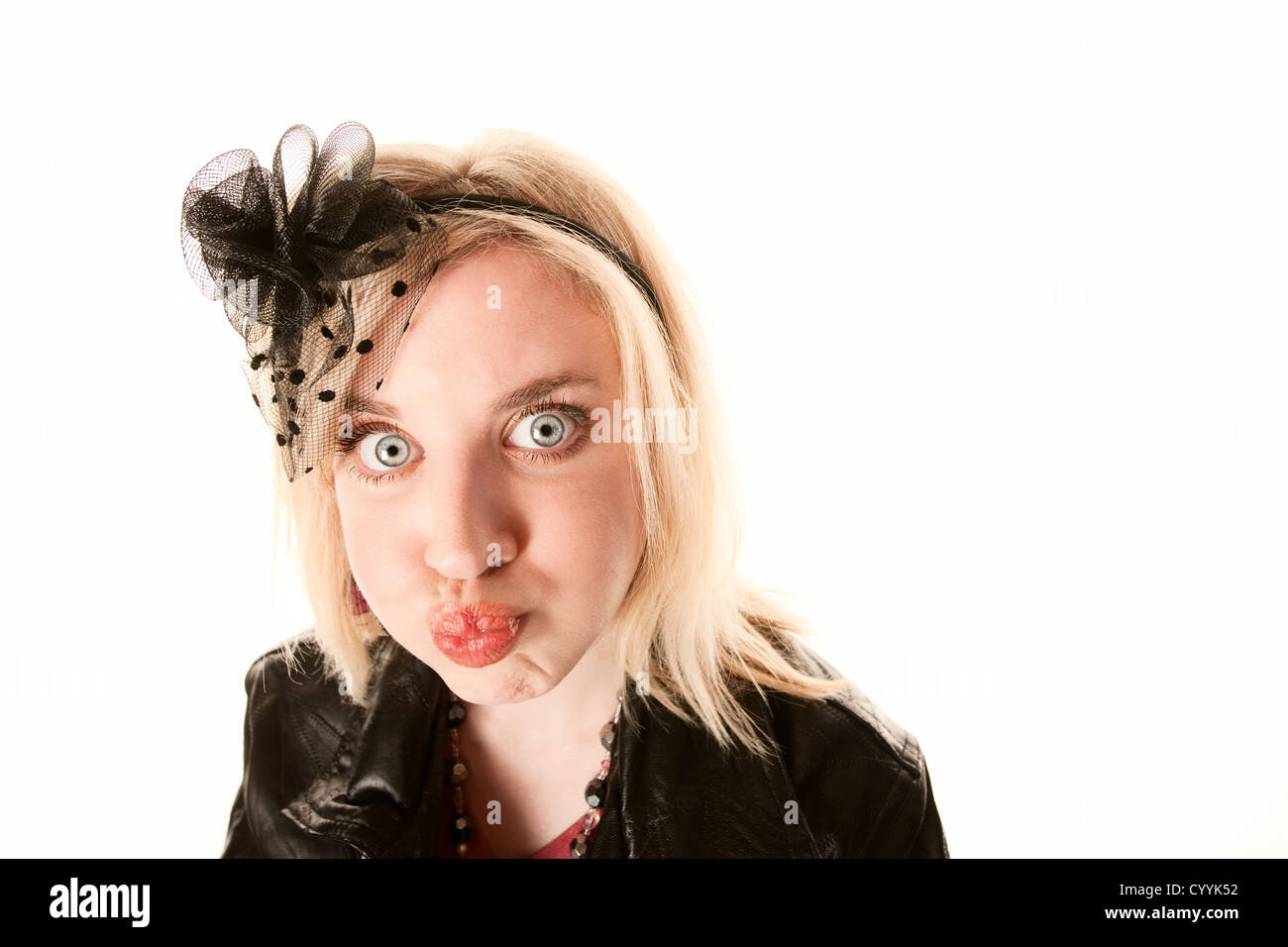 Pretty young woman blowing out her cheeks Stock Photo - Alamy