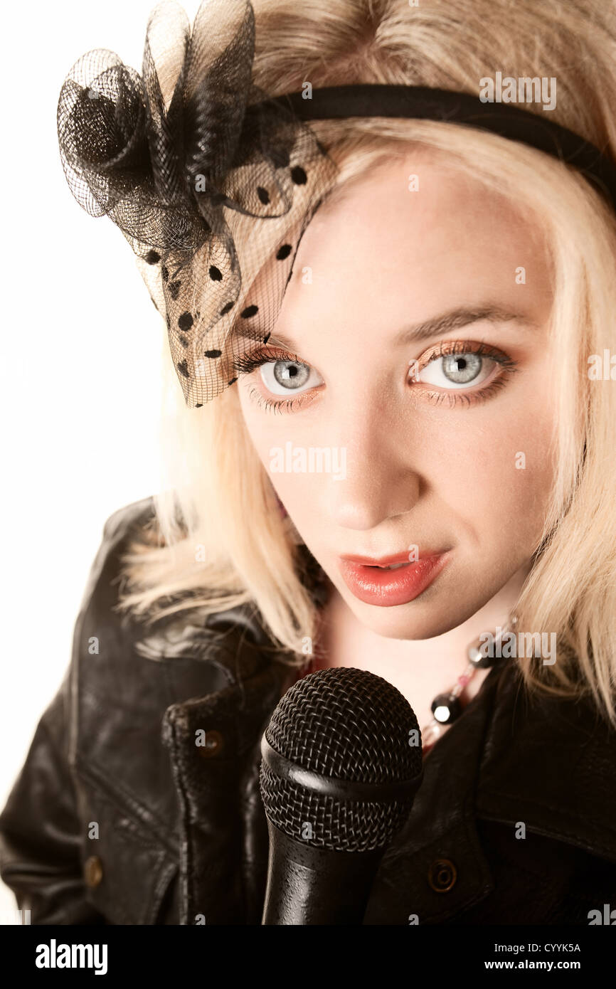 Pretty young female blonde singer or comedian with microphone Stock ...