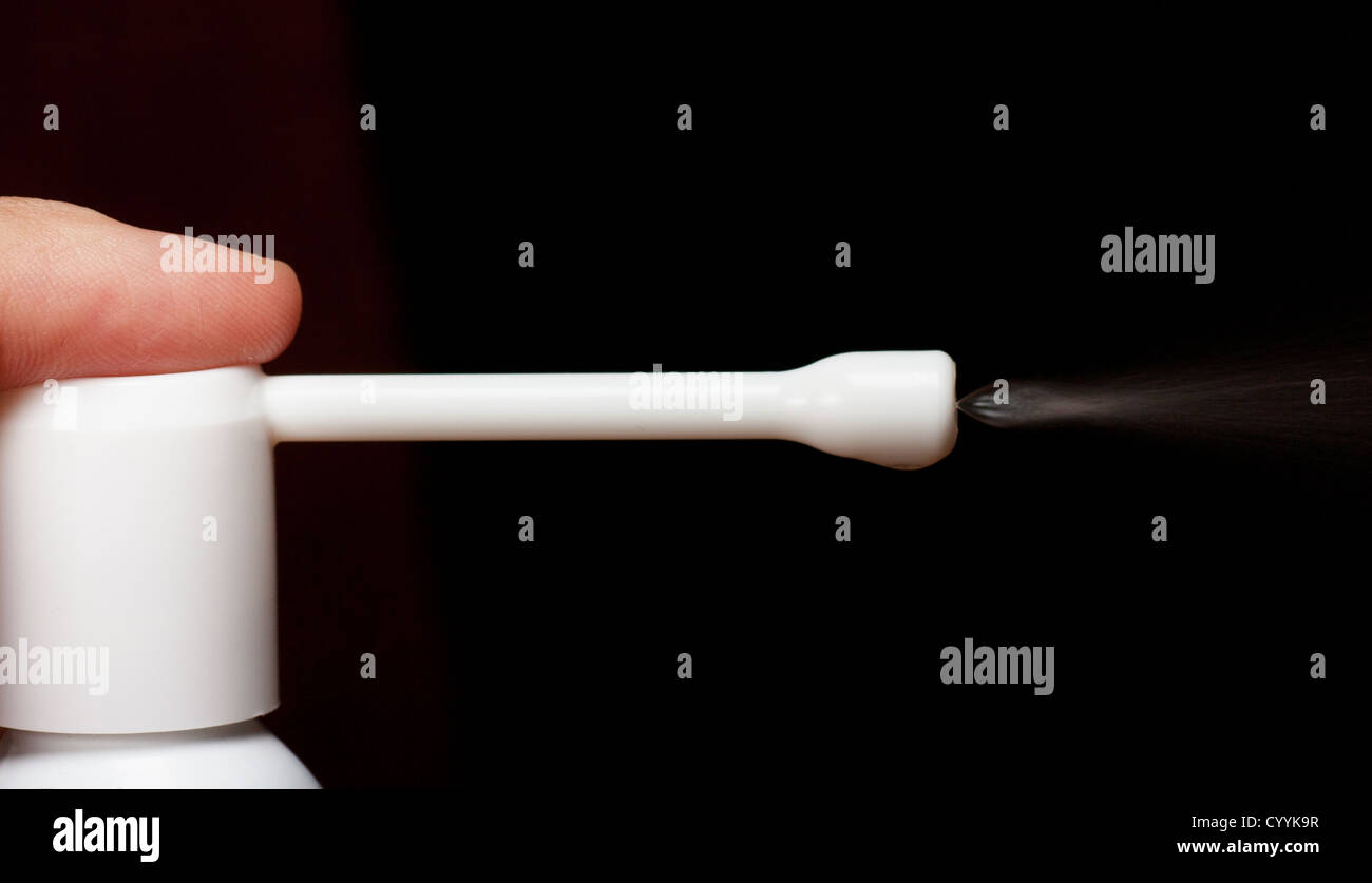 Macro view of medical spray over black background Stock Photo - Alamy