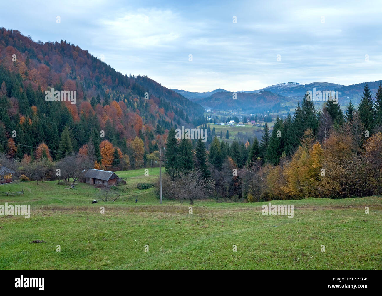 Autumn misty mountain landscape (dull day) with village in valley ...