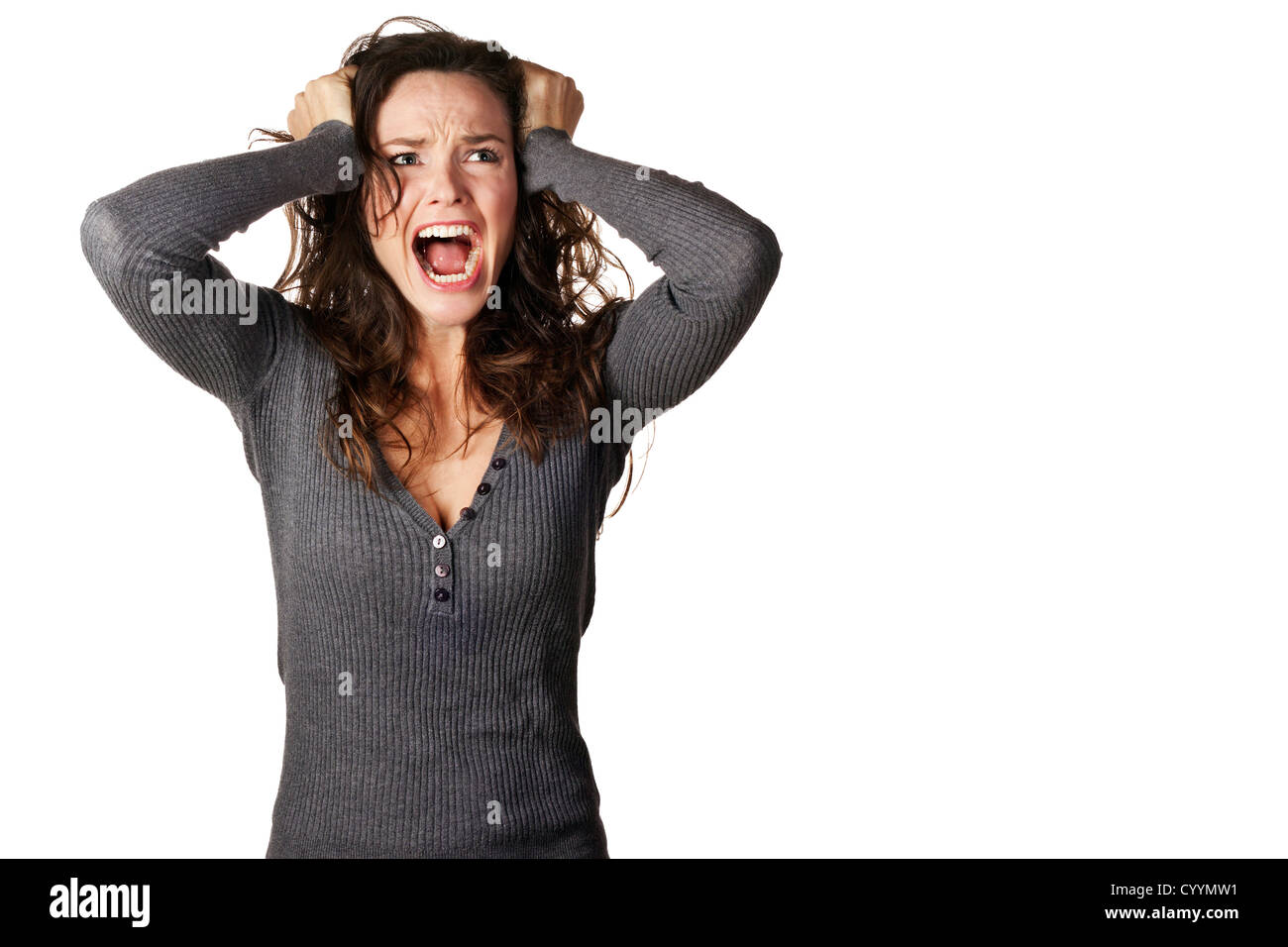 A frustrated and angry woman is screaming out loud and pulling her hair ...