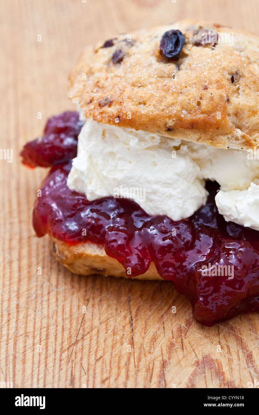 Freshly baked scone with raspberry jam and clotted cream Stock Photo ...