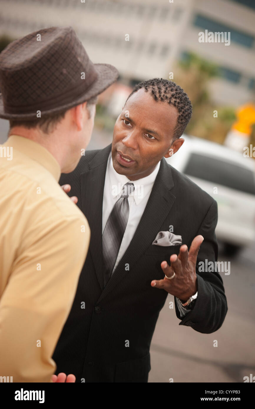 Handsome African-American businessman arguing with his colleague Stock ...