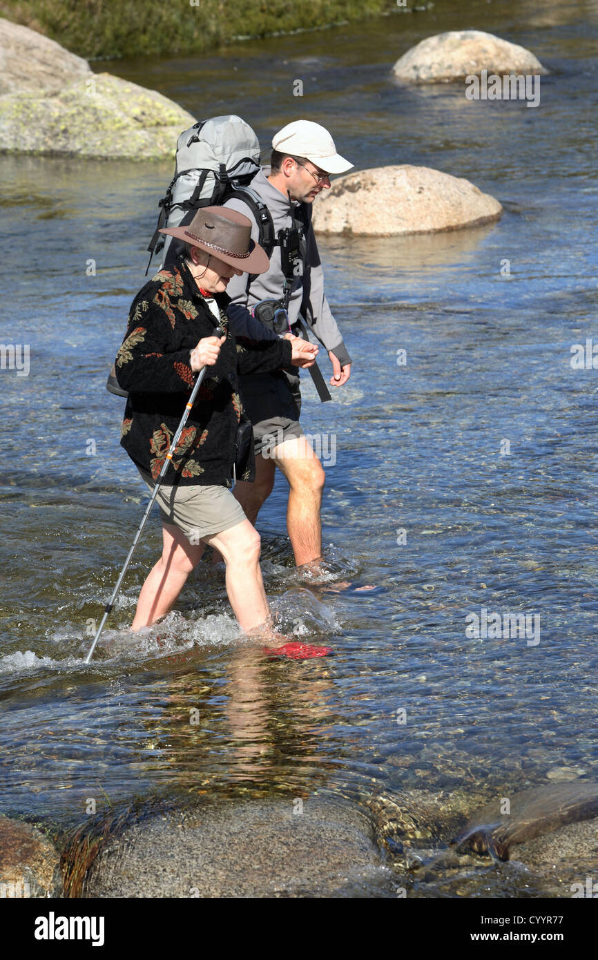 Bushwalkers crossing the Snowy River. Kosciuszko National Park ...