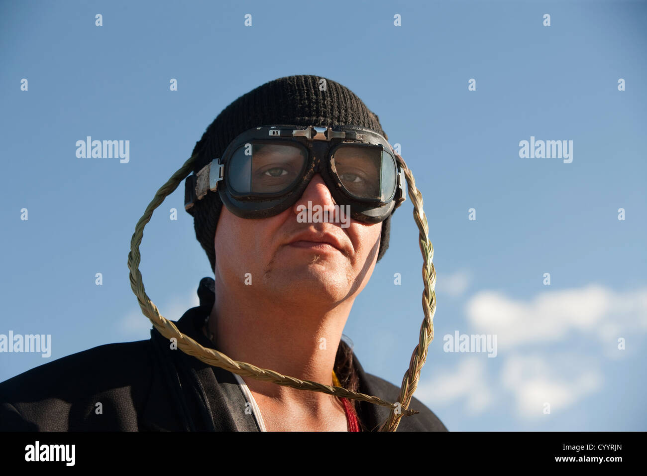 Man with knit cap, goggles and headdress Stock Photo - Alamy