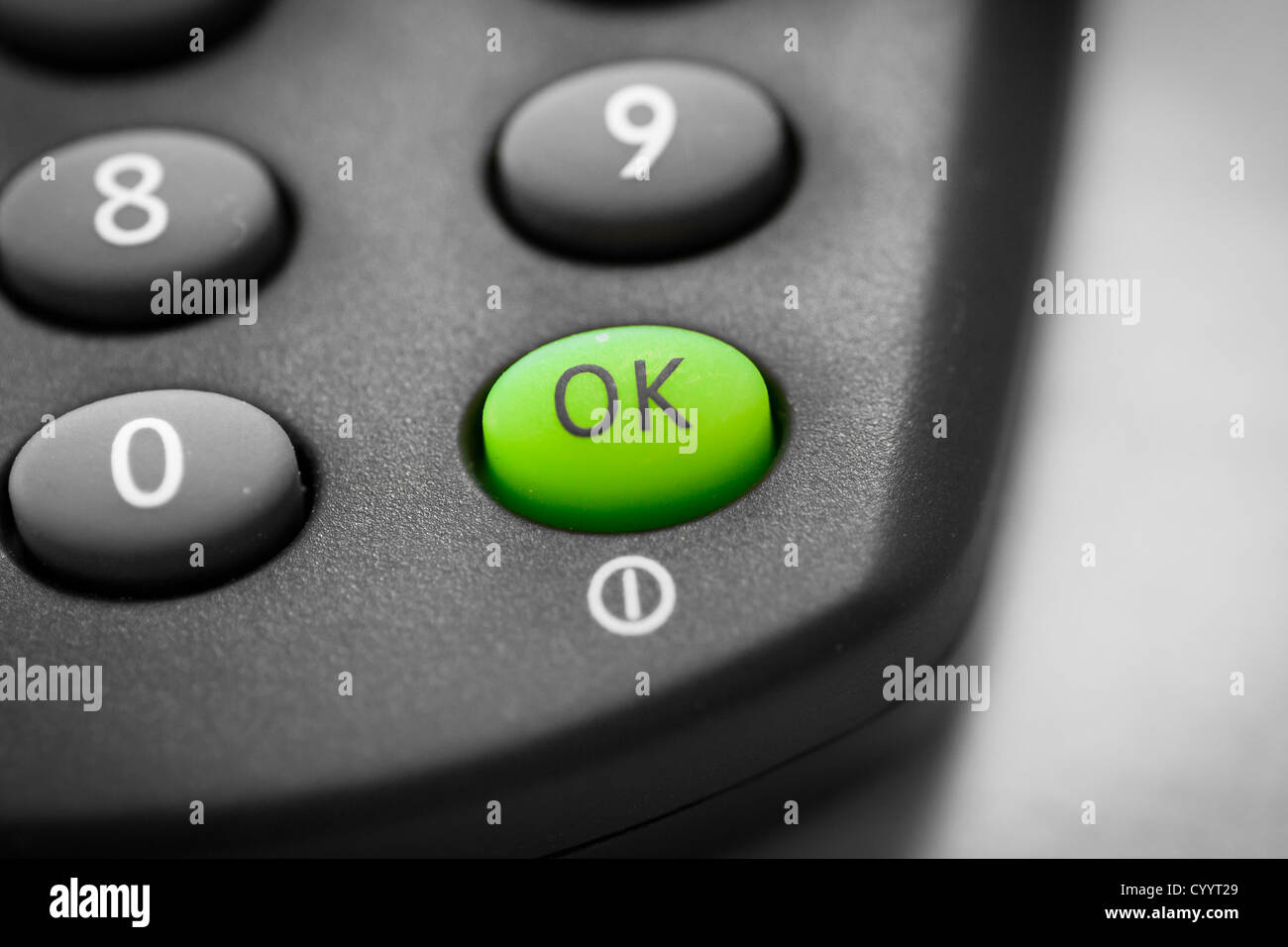 A keypad with a green ok button Stock Photo - Alamy