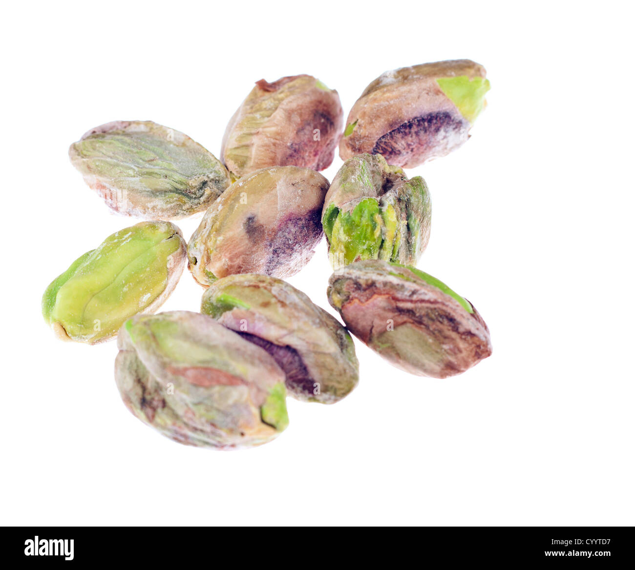 A closeup shot of a bunch of peeled Pistachio nuts. Isolated over white ...
