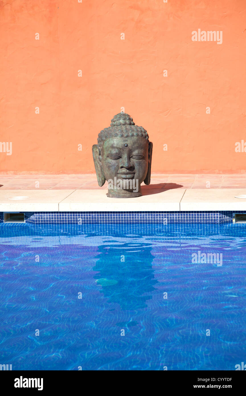 blue swimming pool with an oriental head Stock Photo - Alamy
