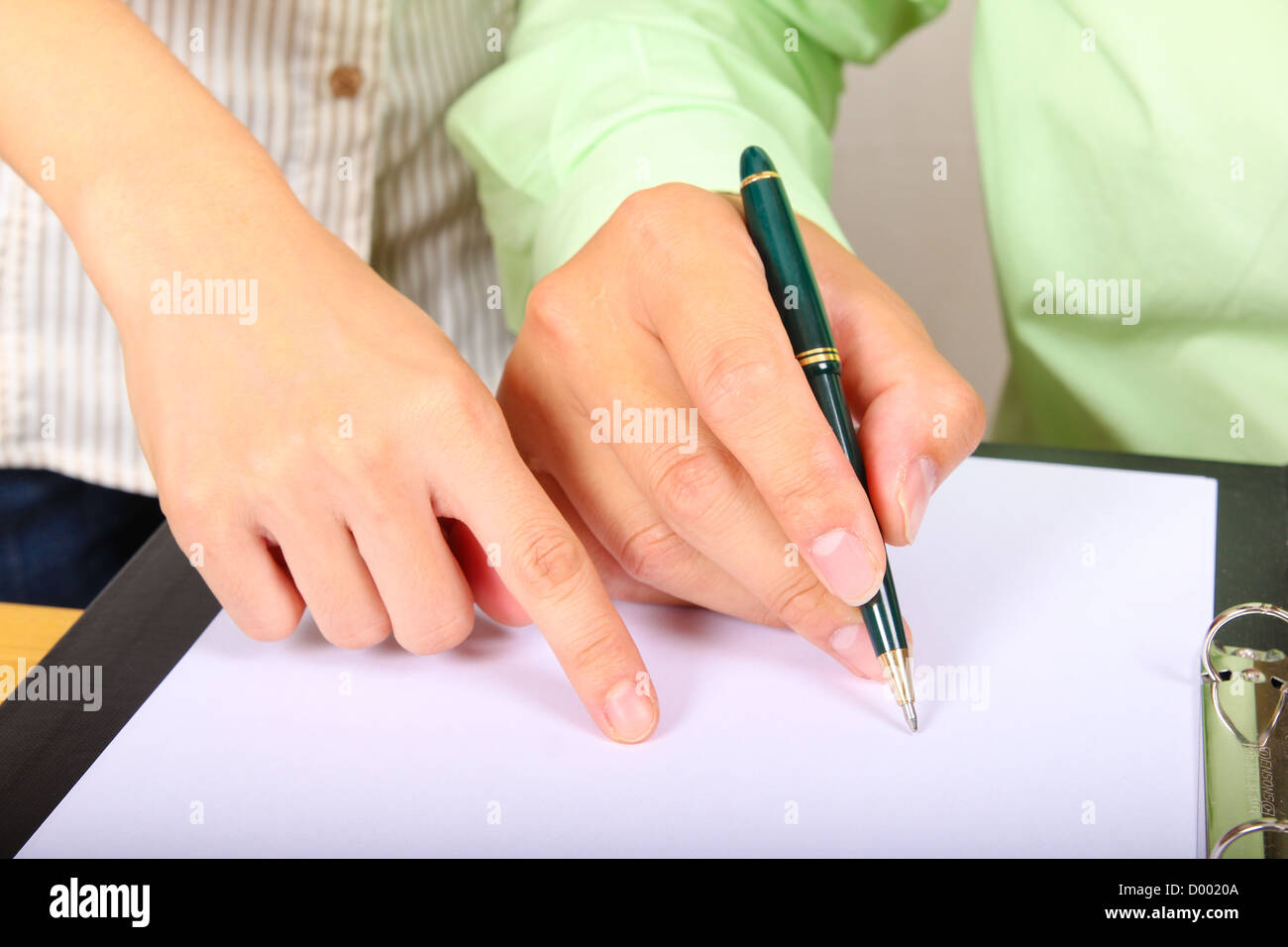 Two businesspeople signing a letter Stock Photo - Alamy