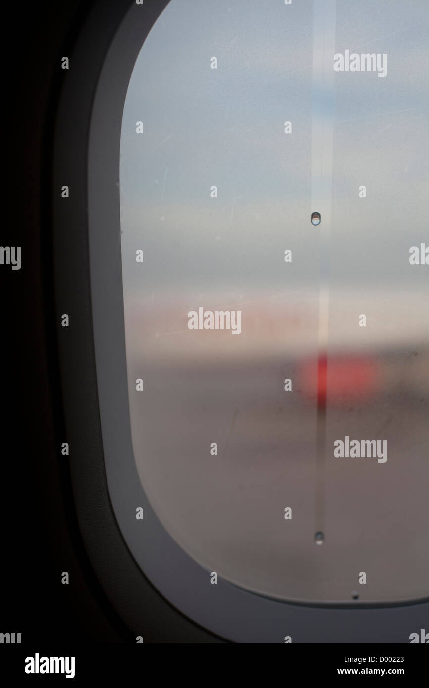 Drops of water run down aircraft window Stock Photo - Alamy