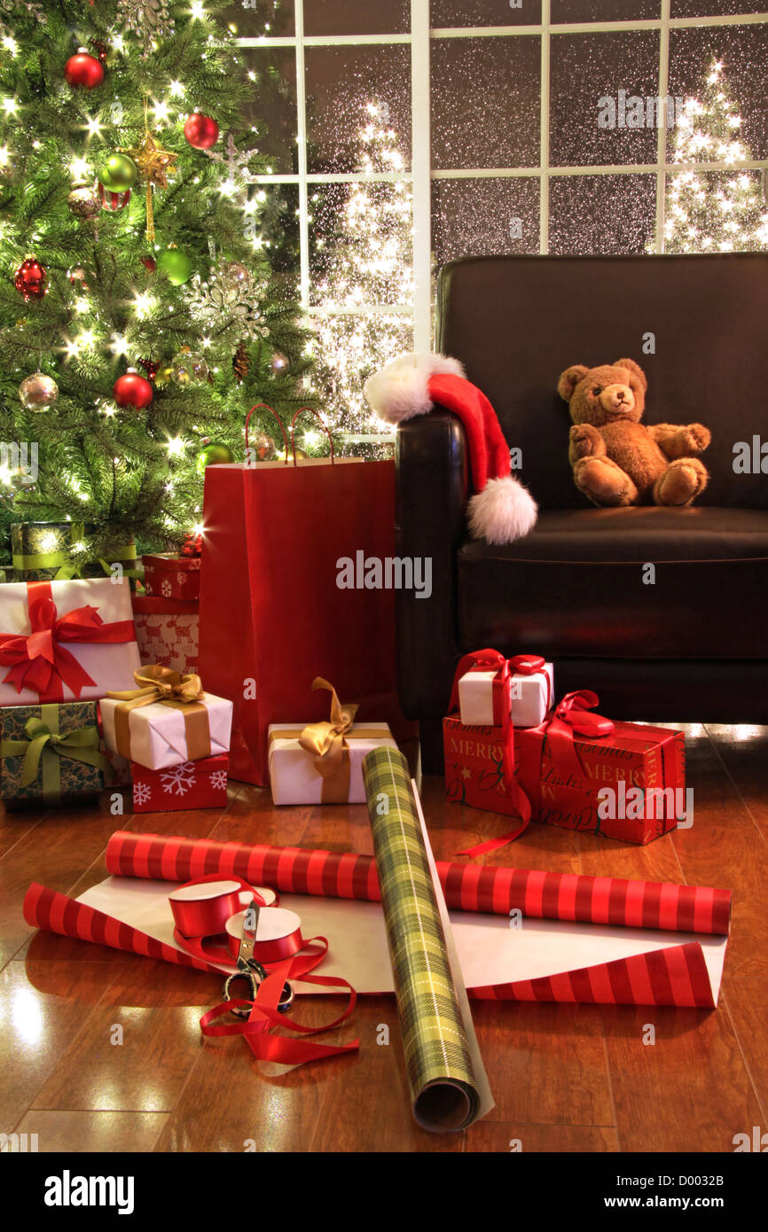 Christmas tree with gifts and teddy bear on chair Stock Photo - Alamy