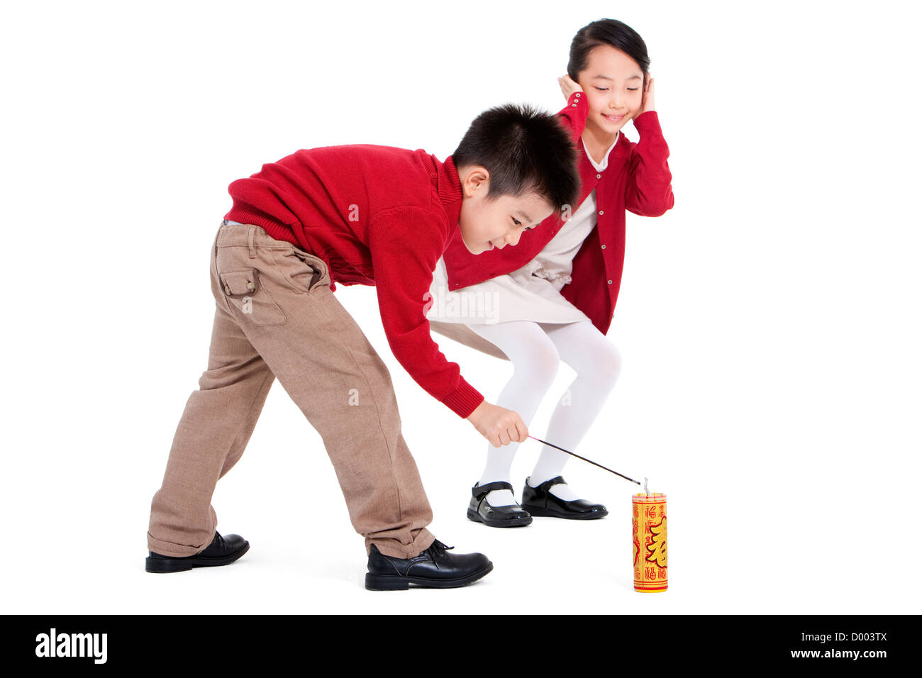 Little boy and little girl igniting firecracker together Stock Photo ...
