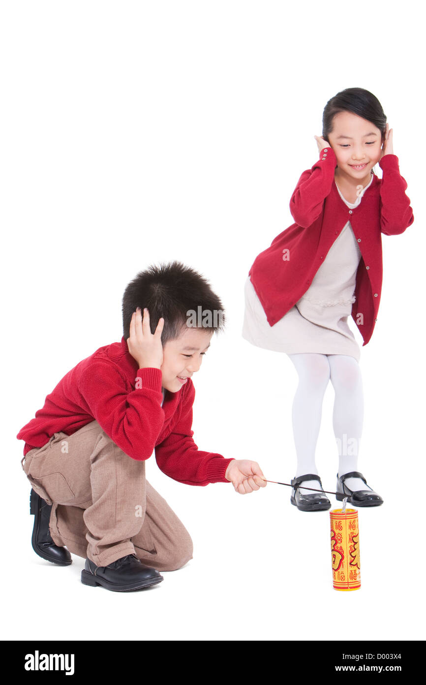 Little boy and little girl igniting firecracker together Stock Photo ...