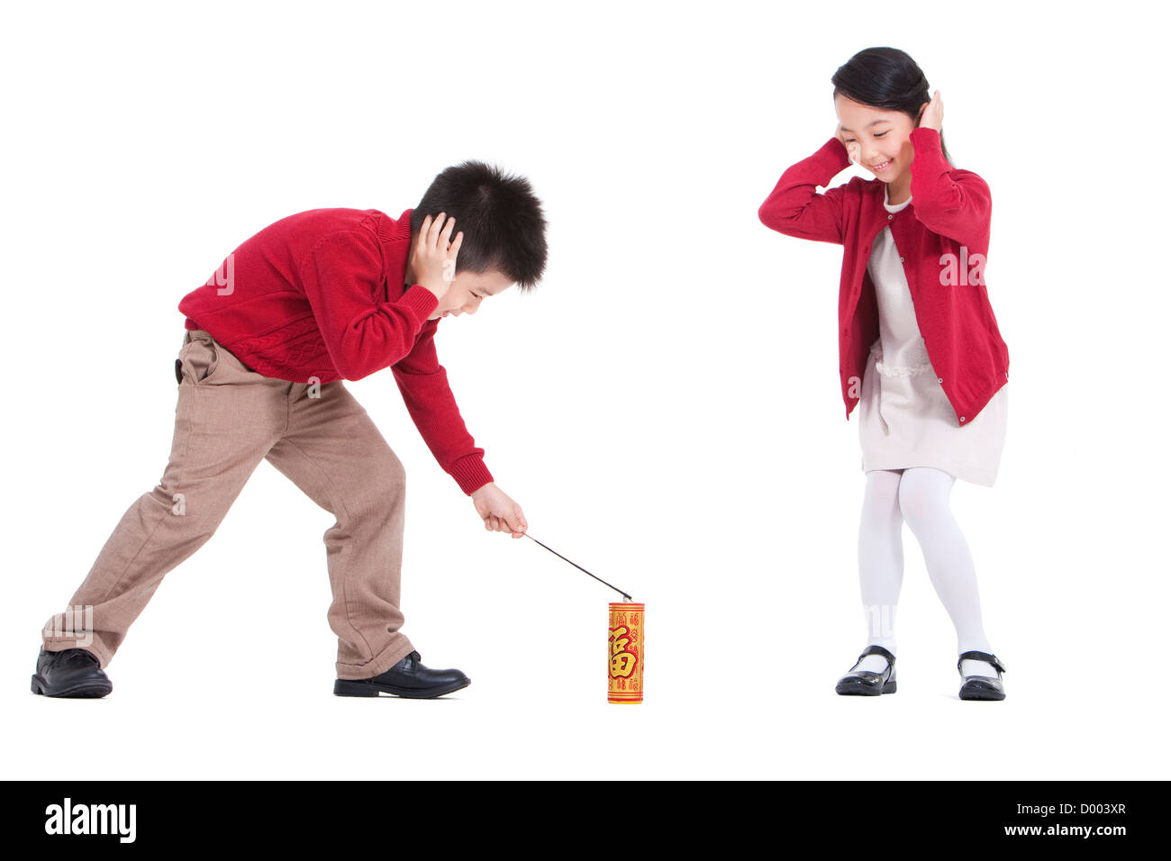 Little boy and little girl igniting firecracker together Stock Photo ...