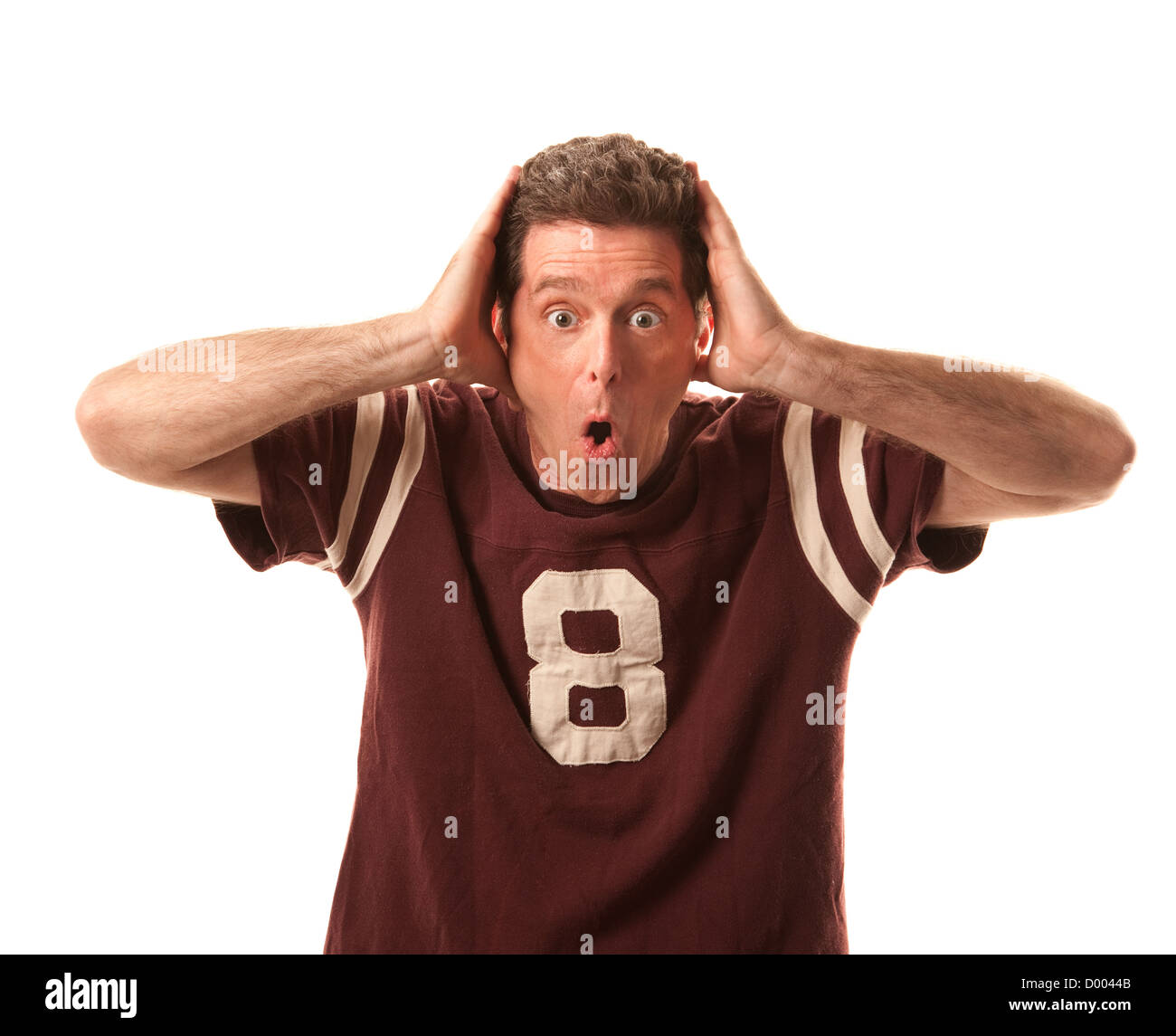 Excited white male sports fan holding his head Stock Photo - Alamy