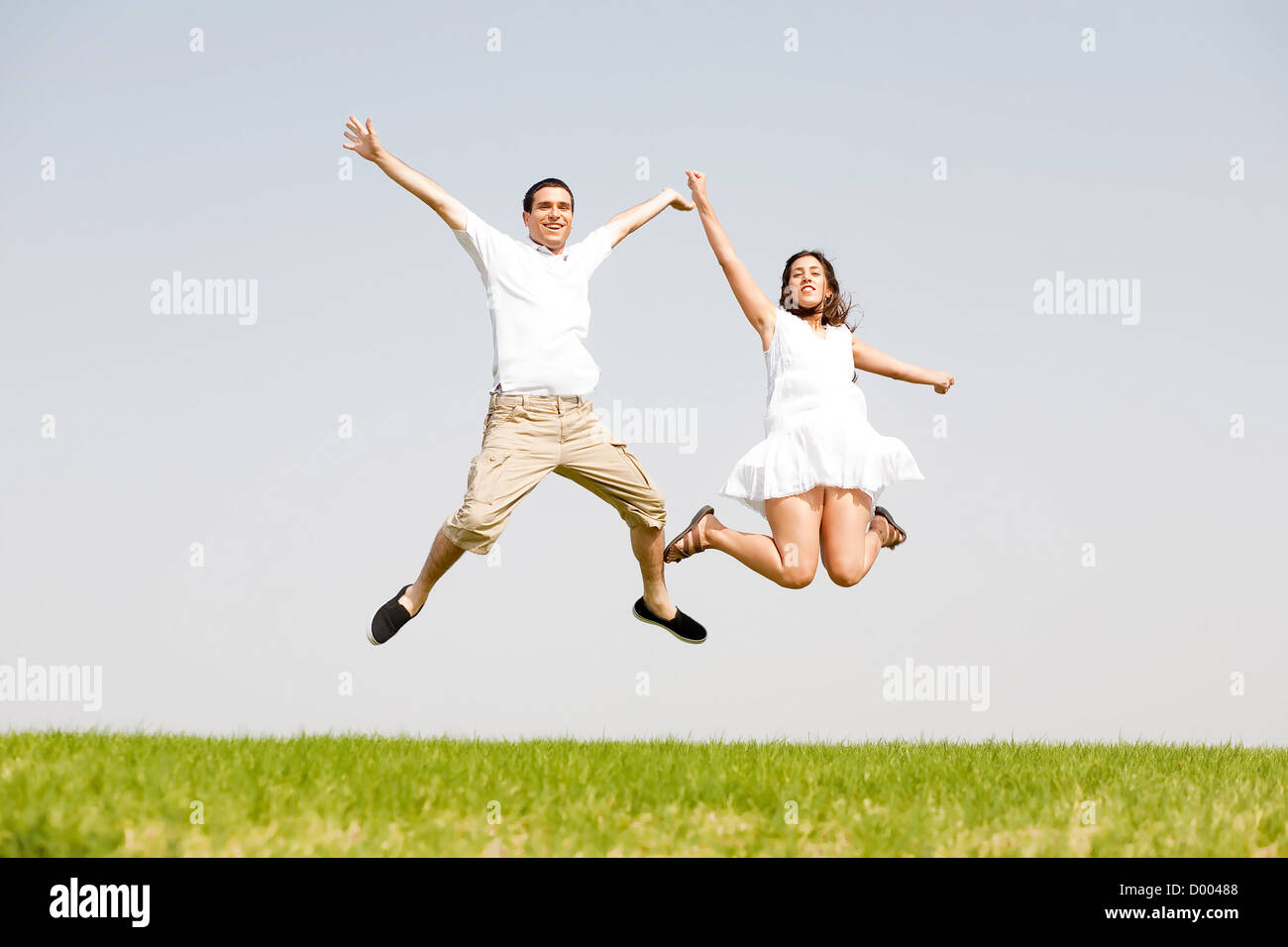 Young Couple Jumping On The park Stock Photo - Alamy