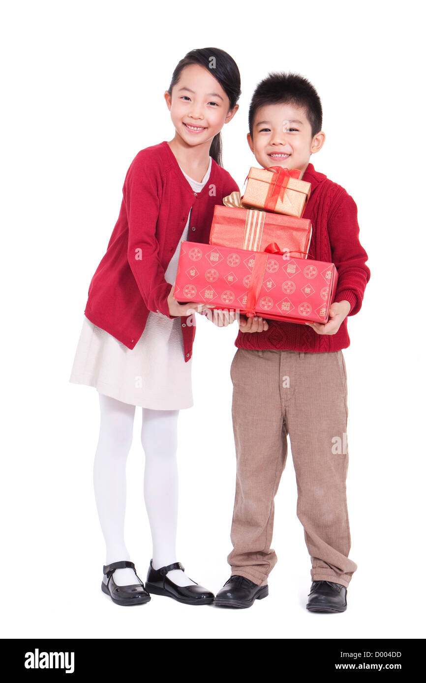 Happy boy and girl holding gift boxes Stock Photo - Alamy