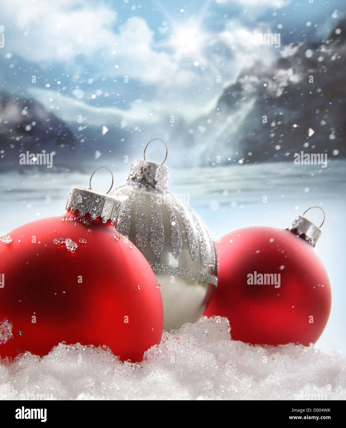 Three red christmas balls in the snow on white Stock Photo - Alamy