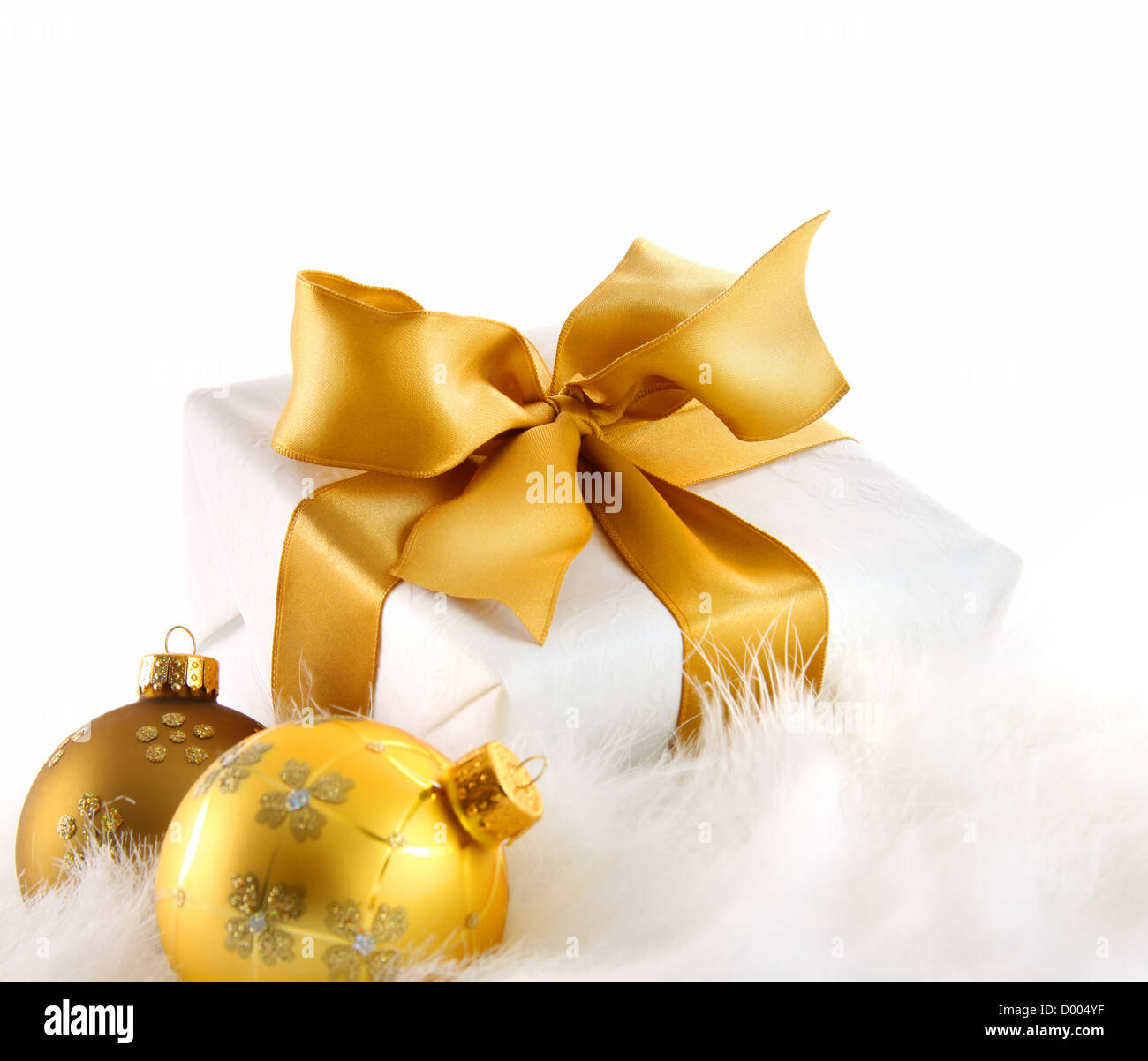 Gold ribbon gift on white background Stock Photo - Alamy