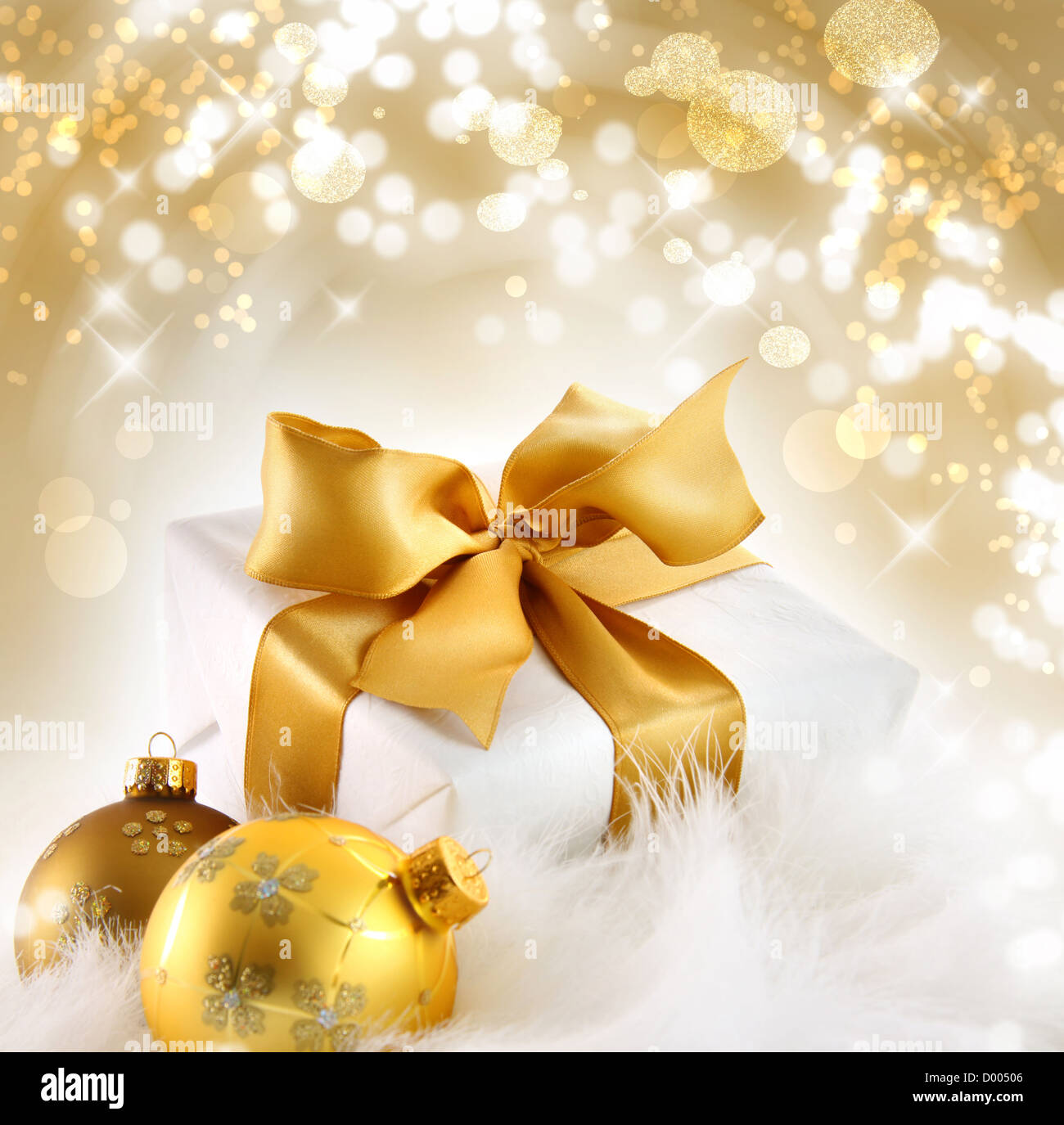 Gold ribboned gift with festive holiday background Stock Photo - Alamy