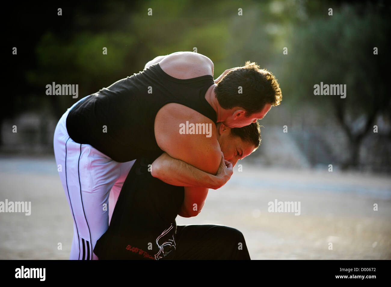 woamn throws man over her shoulder during martial arts class Stock ...