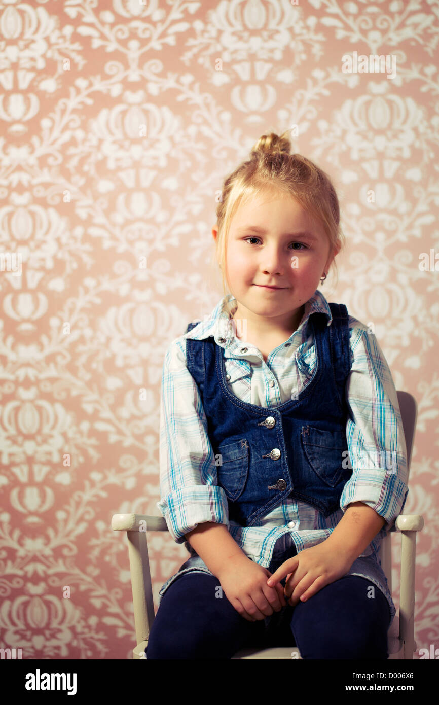little girl sitting on retro chair Stock Photo - Alamy