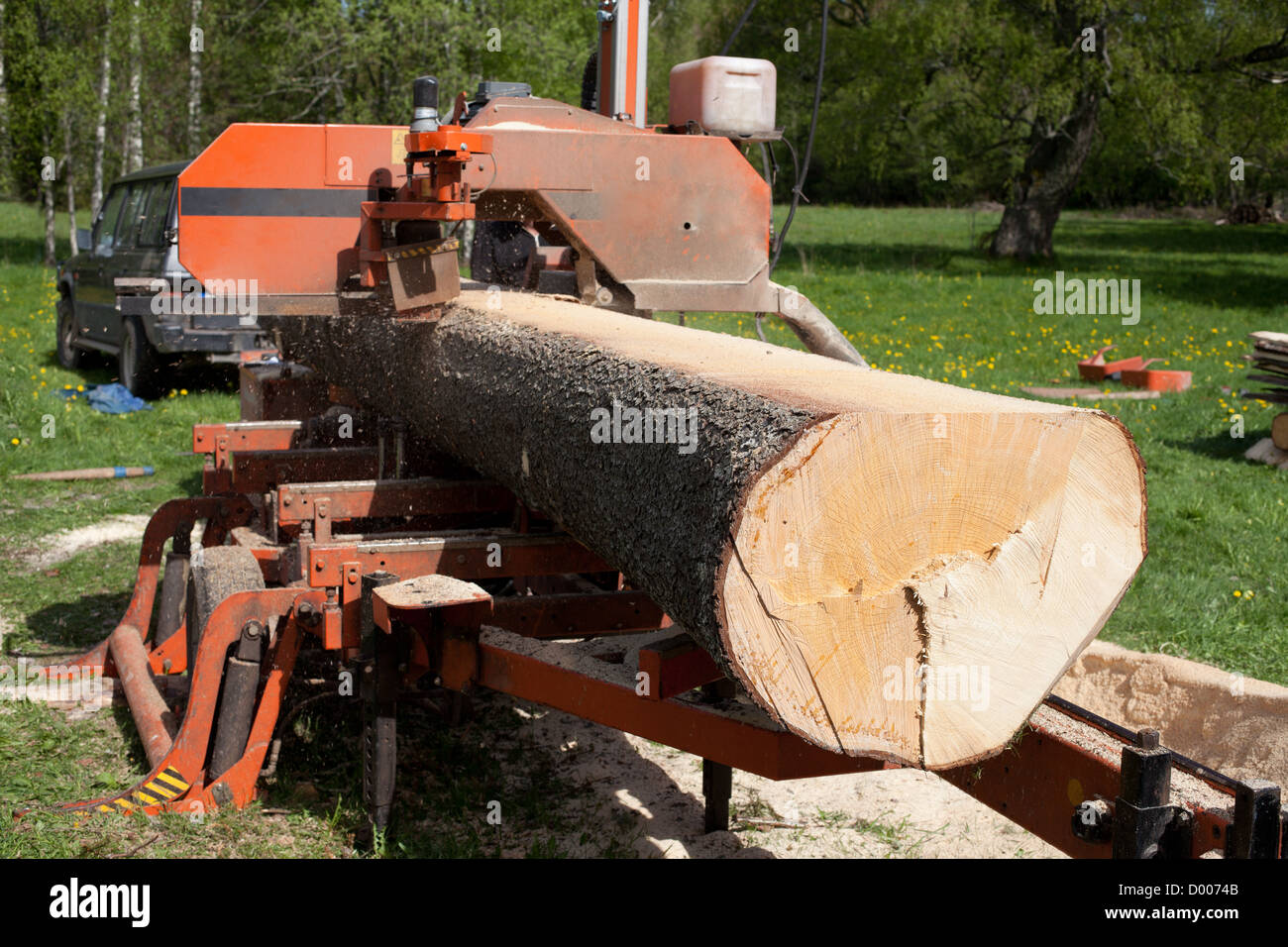 Process of sawing raw wood to plank Stock Photo - Alamy