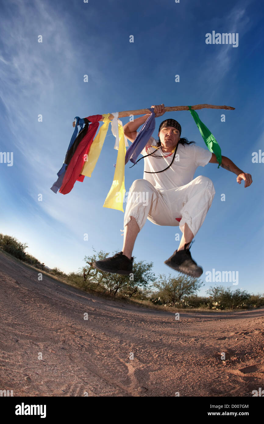 Native American man with colorful flags representing seven directions ...