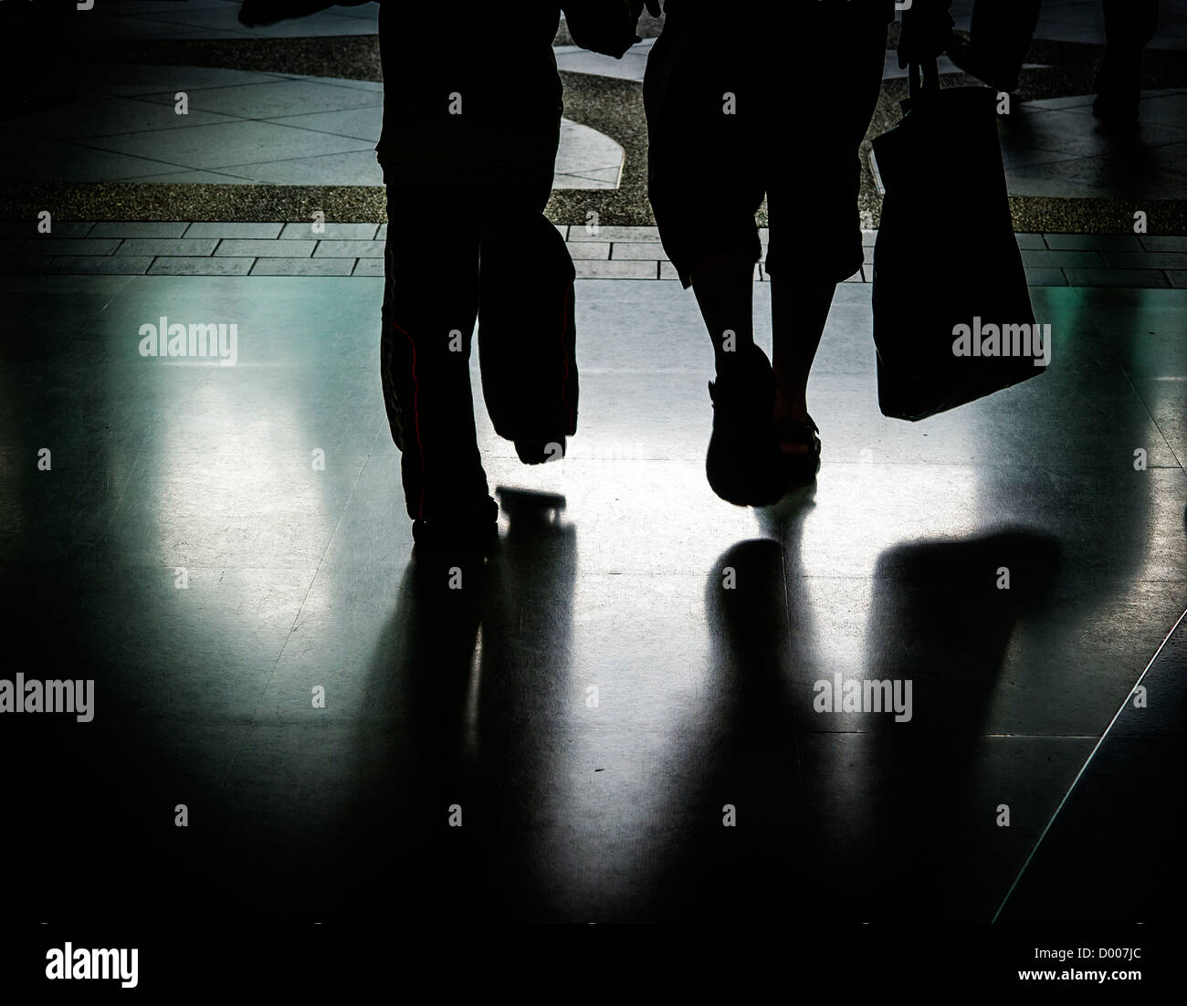 Silhouette of shoppers' feet walking from a shopping Mall in Kuala ...