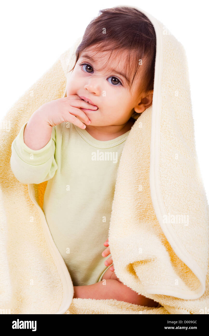 Innocent baby wrapped with a yellow towel in a white isolated ...