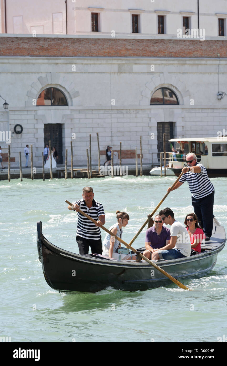 Tourists exploring Venice by gondola, Venice, Italy Stock Photo - Alamy