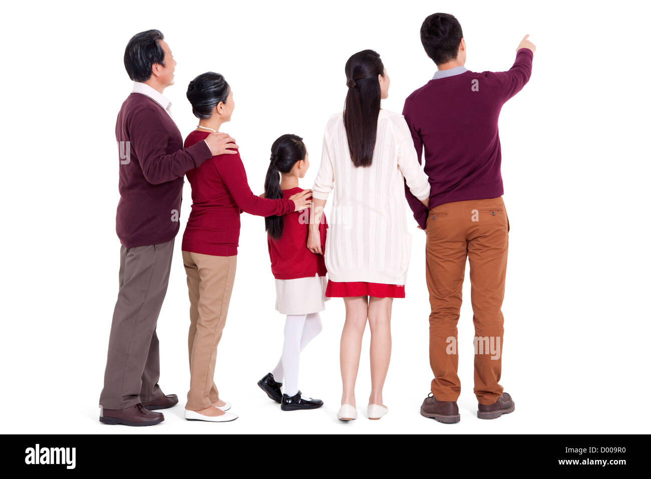 Rear view of family looking at view Stock Photo - Alamy