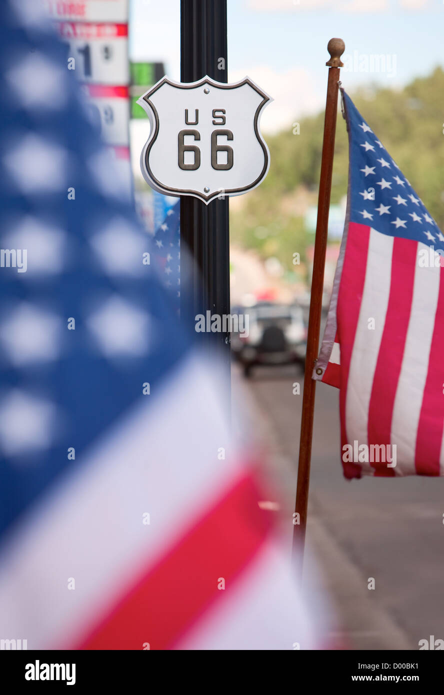 Route 66 sign on side of road with American flags Stock Photo - Alamy