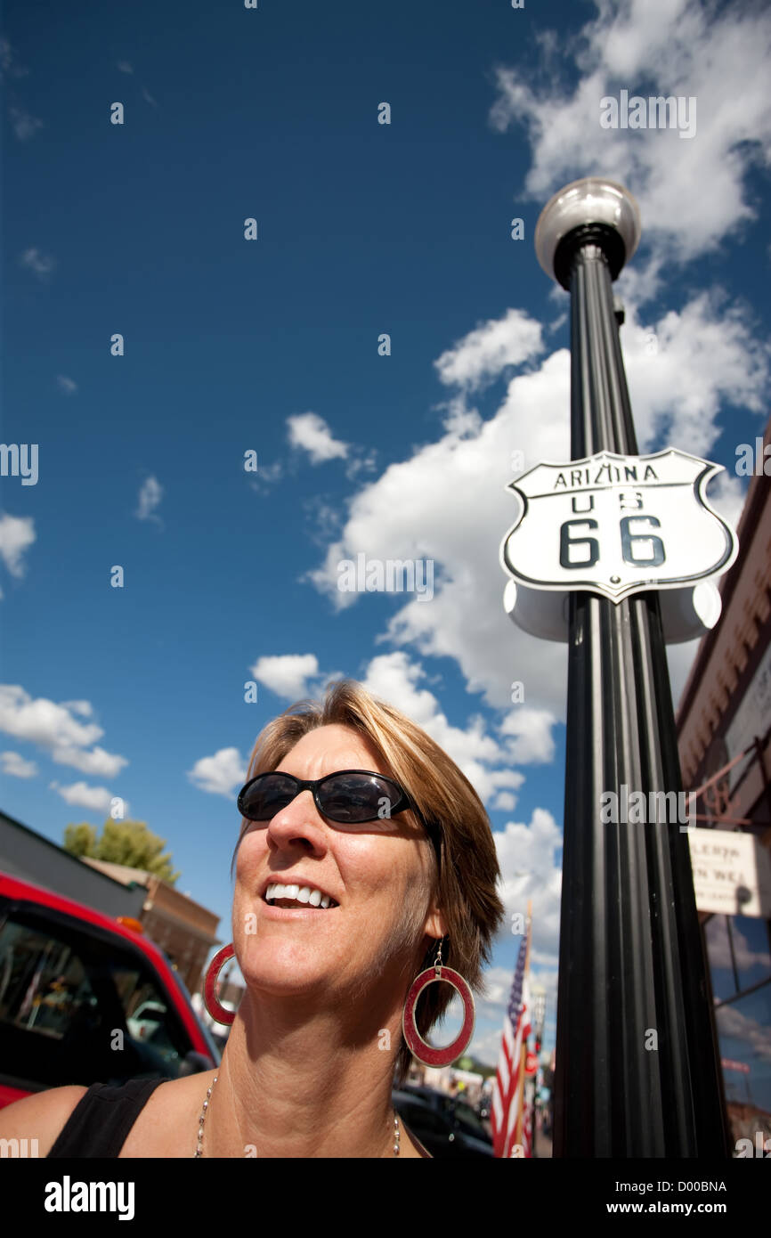 Woman on side of route in front of Route 66 sign Stock Photo - Alamy