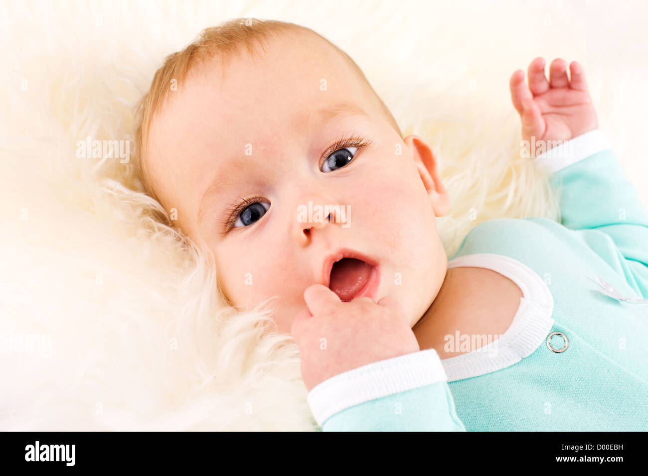 Baby Portrait looking straight at you lying on white fluffy fur Stock ...
