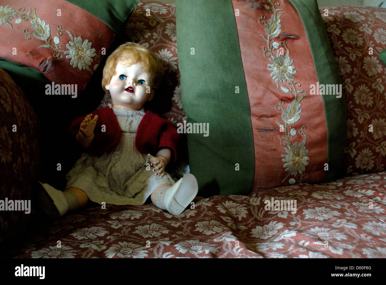 Antique doll sitting on a sofa Stock Photo - Alamy