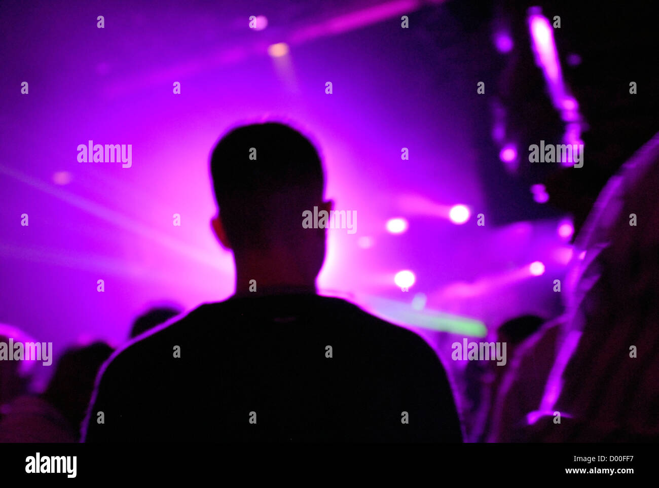 Male figure entering a nightclub light with purple lights Stock Photo ...
