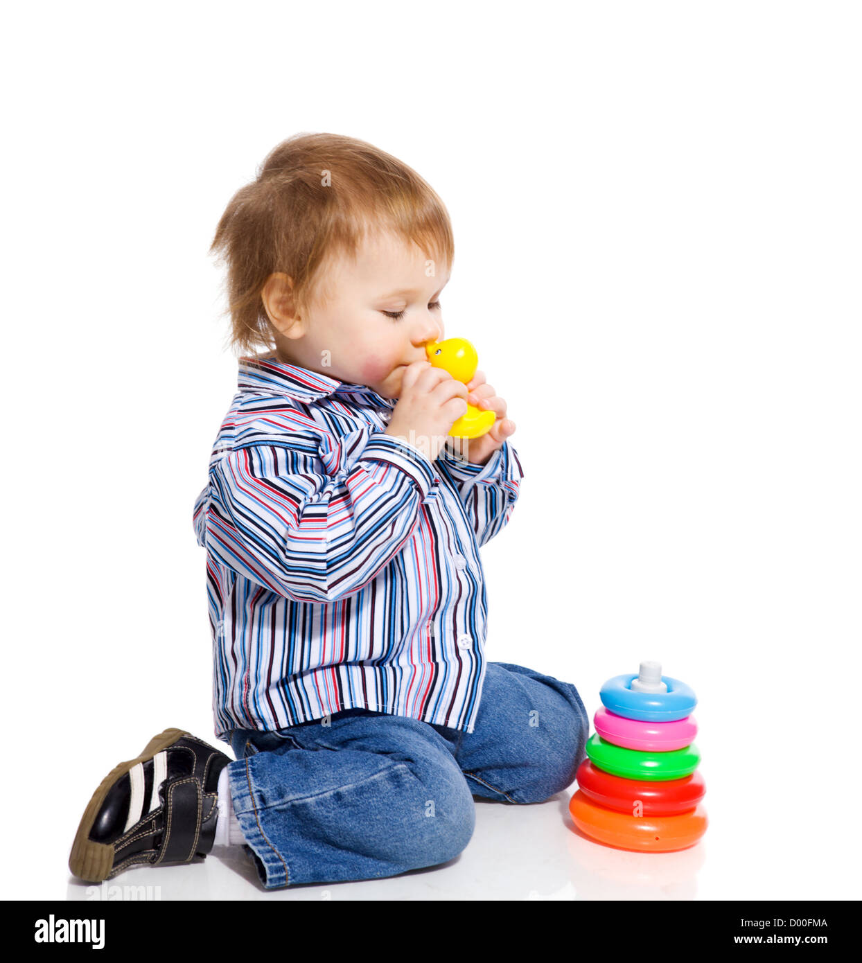 Baby boy playing with colorful pyramid toy isolated on white Stock ...