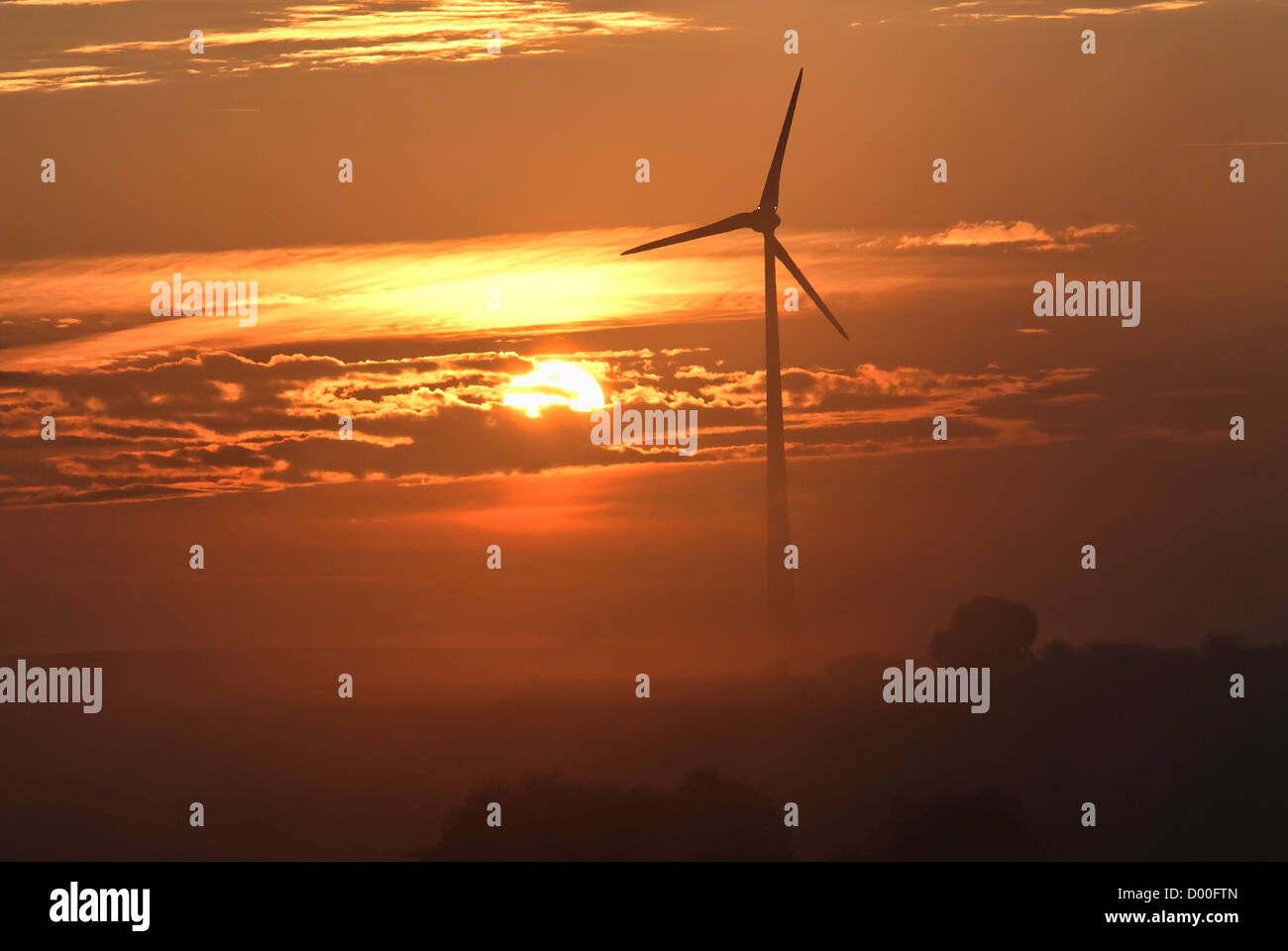 a windmill on sunset background Stock Photo - Alamy
