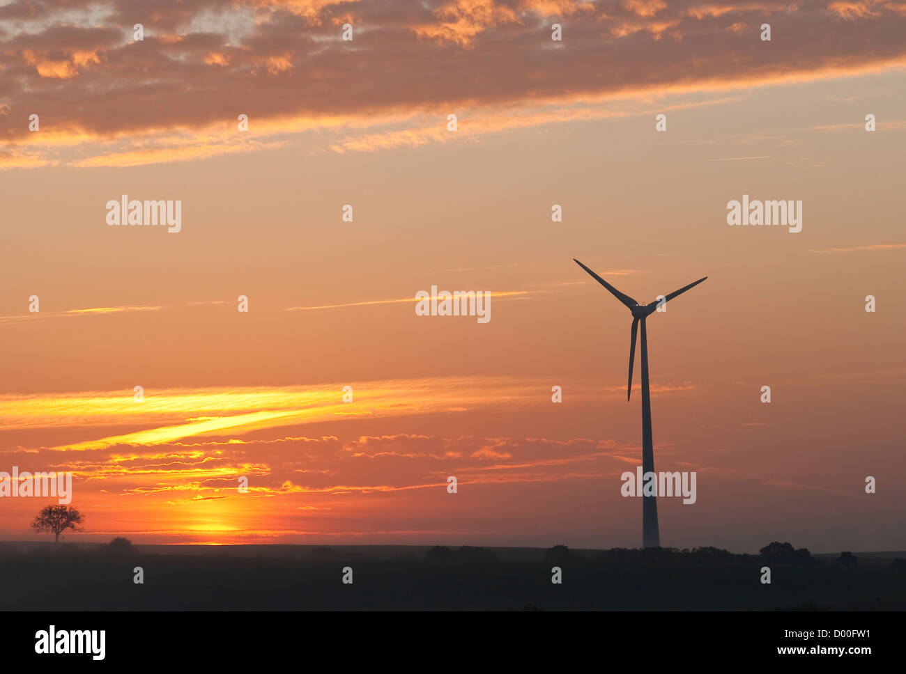 a windmill on sunset background Stock Photo - Alamy