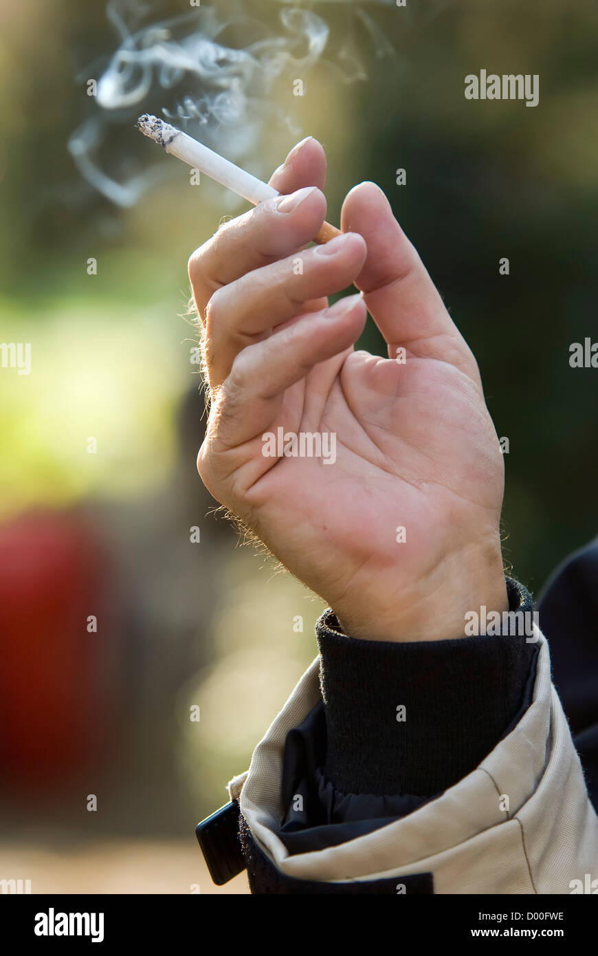 a cigarette in man hand Stock Photo - Alamy