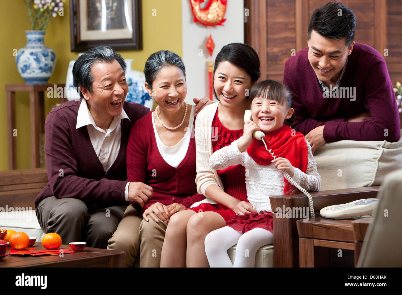 Happy family making phone calls during Chinese New Year Stock Photo - Alamy