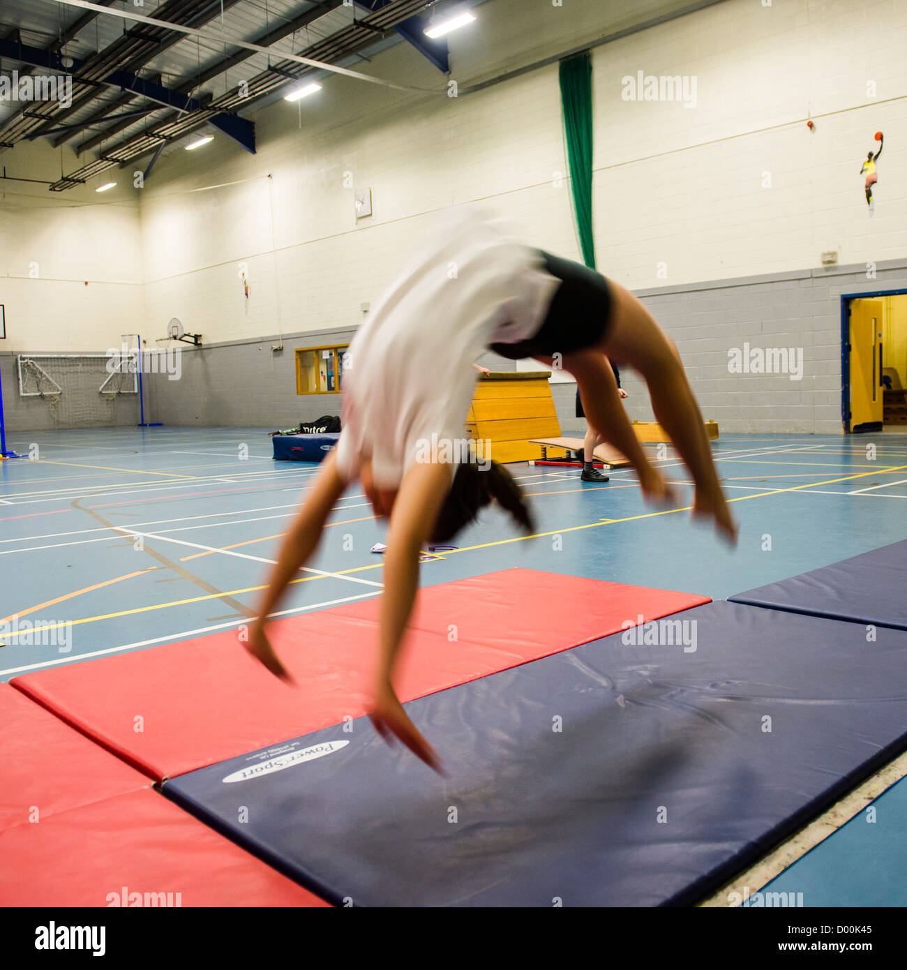 A girl in a Physical education class in the gymnasium at a secondary ...