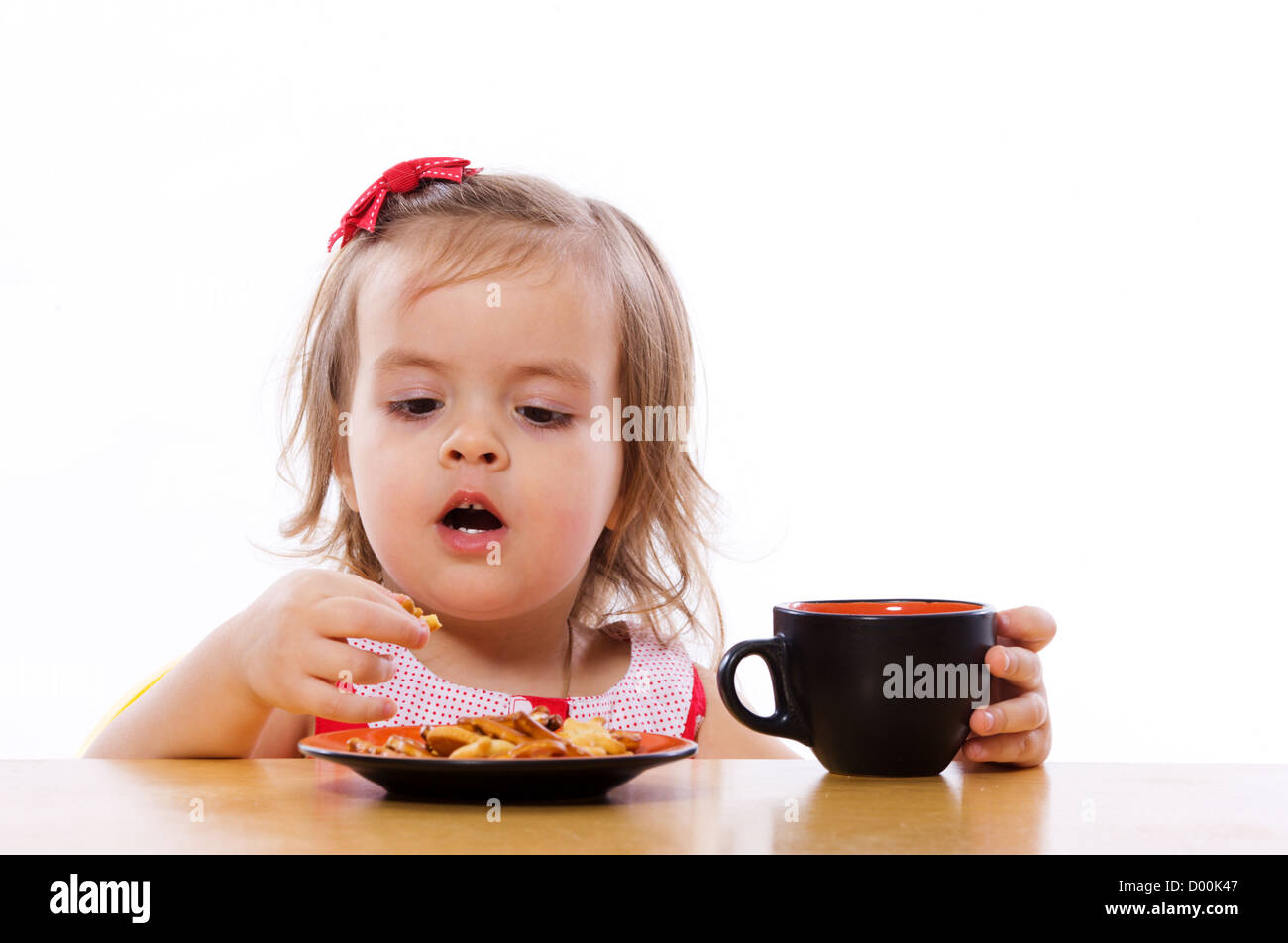 Girl eating tasty cookies isolated on white Stock Photo - Alamy