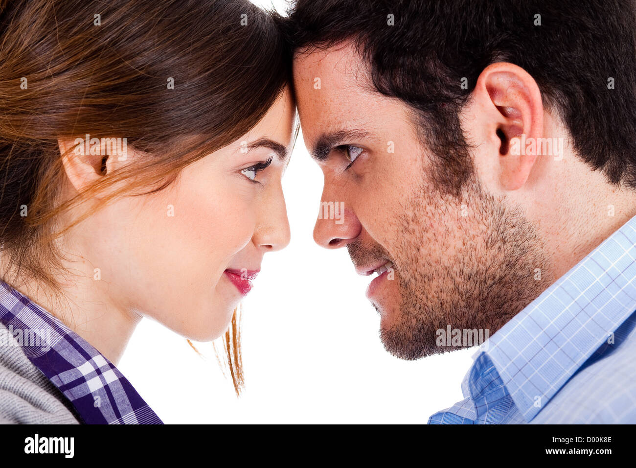 Beautiful couple smiling and facing each other on a isolated white ...