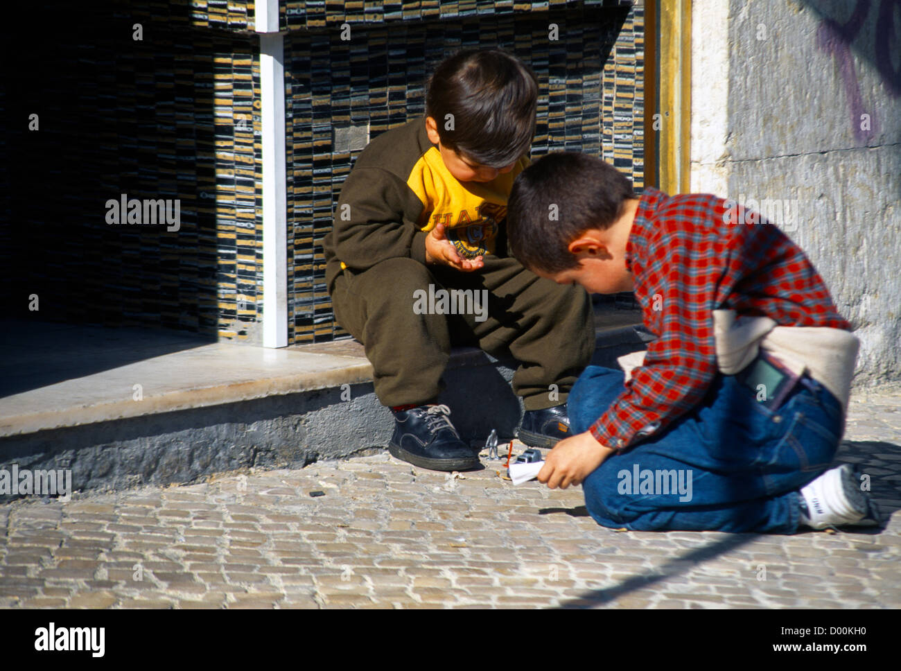 Lisbon Portugal Young Children Playing with toys in Street Stock Photo ...