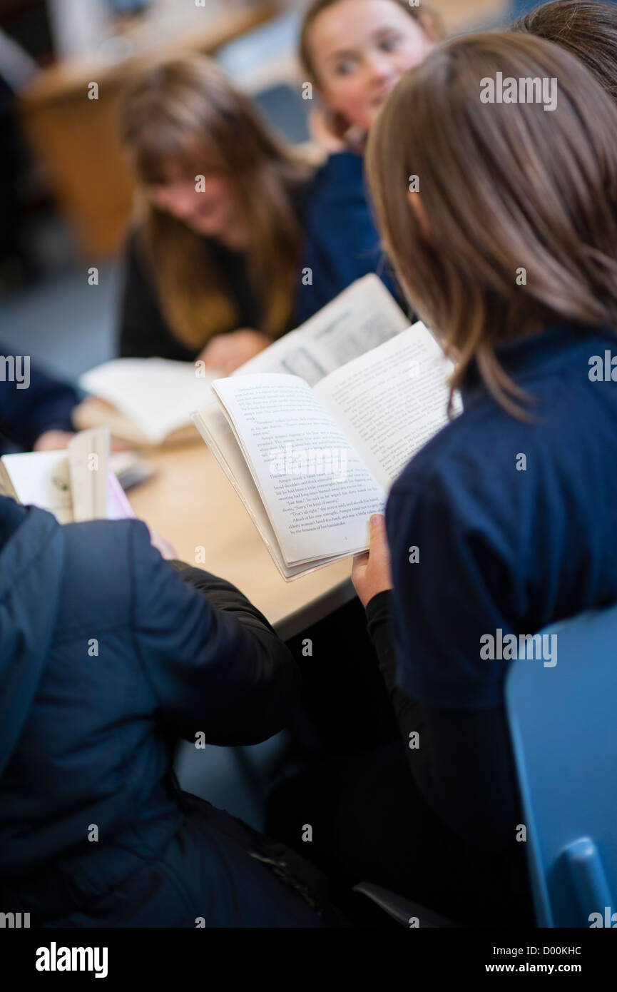 Schoolgirls reading books in the library at a secondary comprehensive ...